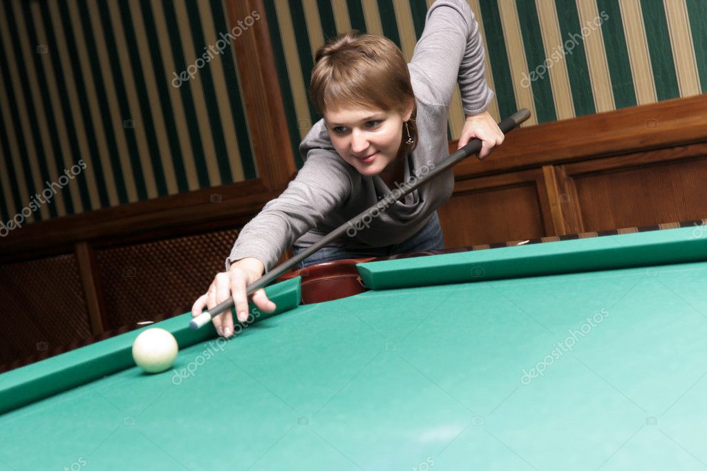 Woman strikes billiard ball — Stock Photo © AChubykin #1086875