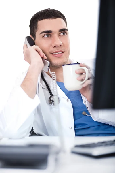 Young doctor talking over phone - Stock Image - Everypixel