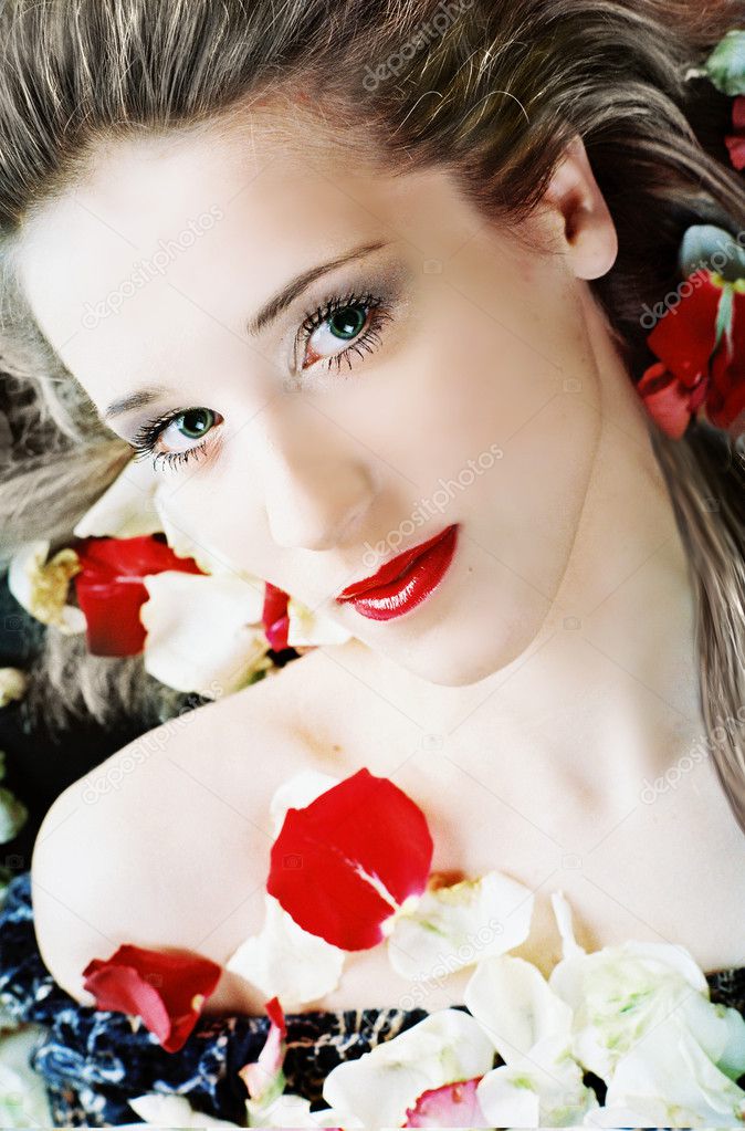Beautiful girl with rose petals — Stock Photo © Rozaliya #1390569