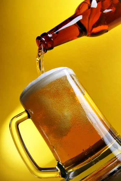 Pouring beer over yellow — Stock Photo #1440864 - Stock Image - Everypixel