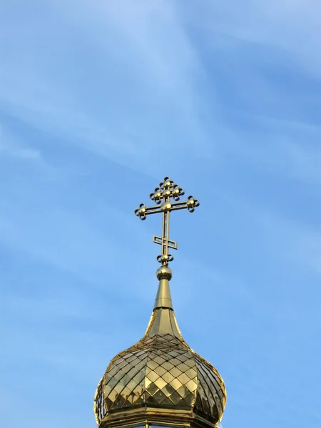 Gold religious sign on blue sky, clouds - Stock Image - Everypixel