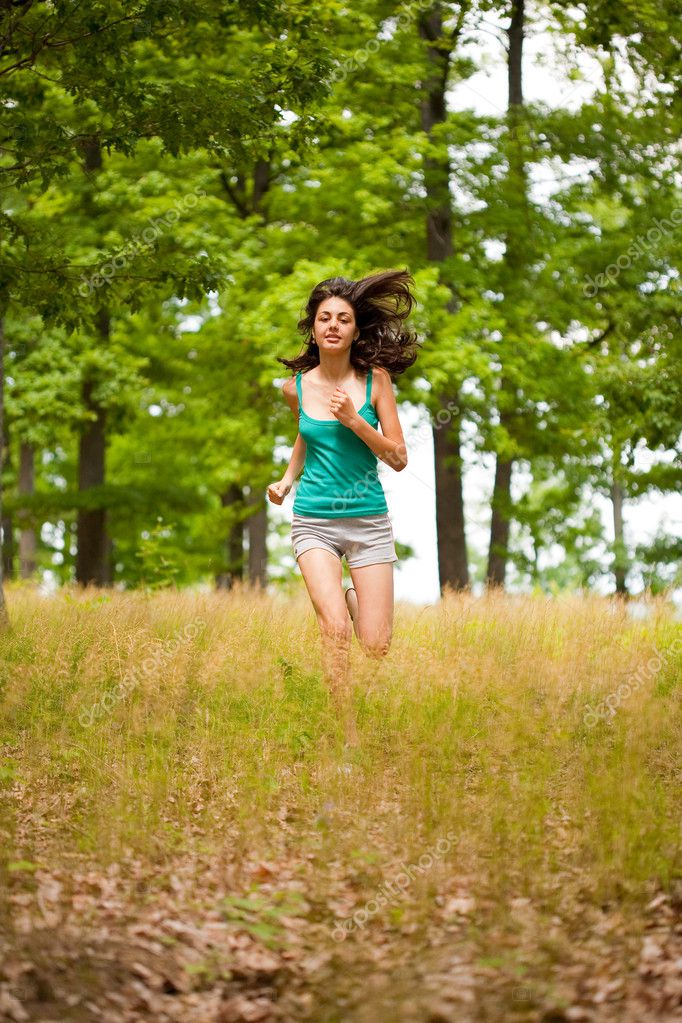 Beautiful girl running through forest — Stock Photo © Xalanx #2211603