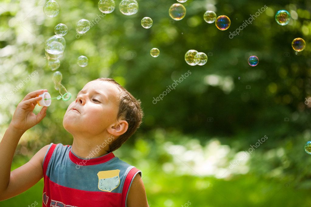 Cute kid blowing soap bubbles — Stock Photo © Xalanx #2214503 Cute kid blowing soap bubbles — Stock Photo © Xalanx #2214503